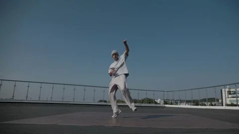 The guy coolly dances breakdance on the ... | Stock Video | Pond5