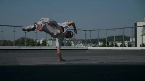 The guy coolly dances breakdance on the ... | Stock Video | Pond5
