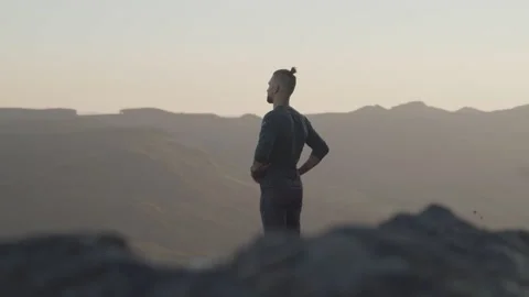 Guy Looks Out At Mountain Range | Stock Video | Pond5