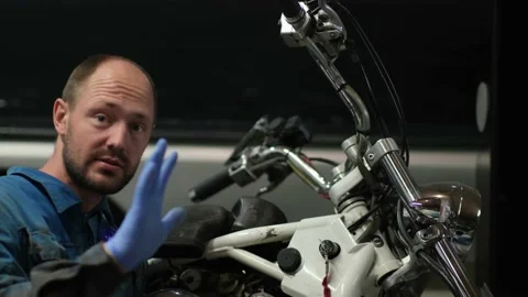 guy mechanic in blue overalls next to a ... | Stock Video | Pond5