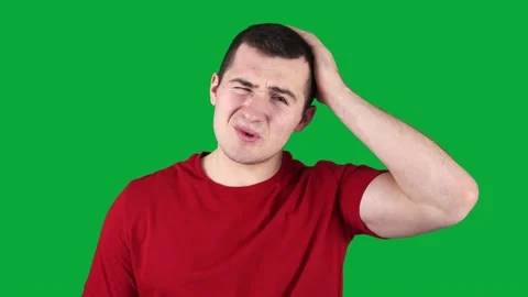 guy scratches his head on a green screen | Stock Video | Pond5