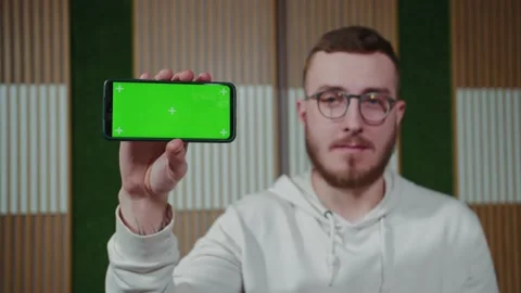 The guy shows the phone in a horizontal ... | Stock Video | Pond5