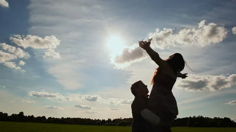 The guy turns the girl against the sun. ... | Stock Video | Pond5