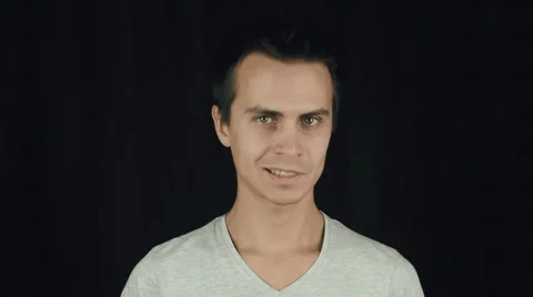 Guy in white t-shirt make a creepy smile... | Stock Video | Pond5