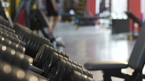 Guys taking and putting back heavy dumbb... | Stock Video | Pond5