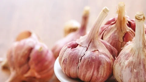 Gyration old garlic on a plate on a wood... | Stock Video | Pond5