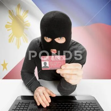 Photograph: Hacker with flag on background holding ID card in hand ...
