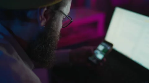 Hacker hacking late at night in neon lig... | Stock Video | Pond5