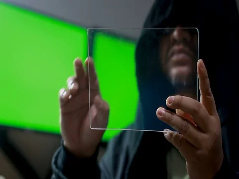 Hacker using clear glass tablet with gre... | Stock Video | Pond5