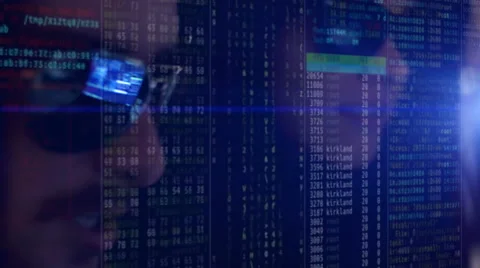 Hacker using laptop. Lots of digits on t... | Stock Video | Pond5