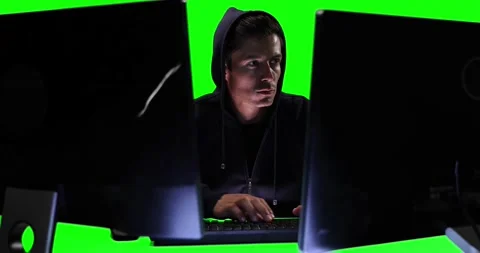 Hacker using two computers with green sc... | Stock Video | Pond5