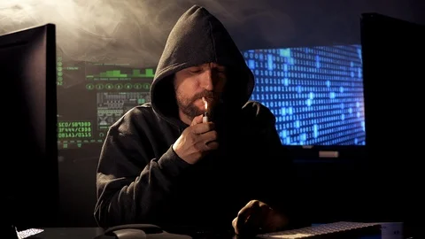 Hacker working at night in studio smokin... | Stock Video | Pond5
