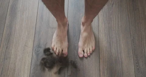 Hair falls on bare feet. Top view, indoo... | Stock Video | Pond5