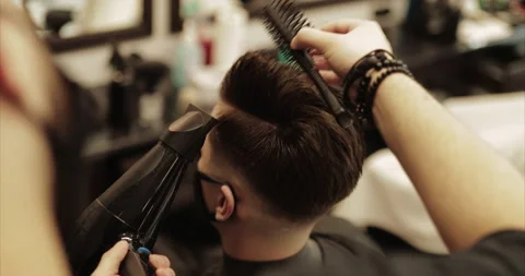 Hair styling. Barber completes the hairc... | Stock Video | Pond5