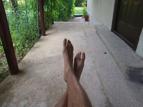 Hairy legs of a man playing with toes an... | Stock Video | Pond5