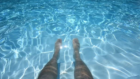 Hairy male legs in blue clear water, out... | Stock Video | Pond5