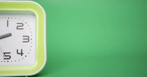 Half alarm clock on green background. | Stock Video | Pond5