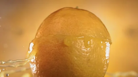 Half Lemon falling and splashing on yell... | Stock Video | Pond5