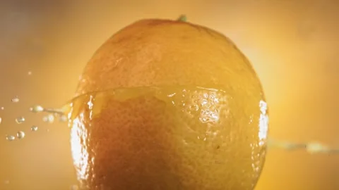 Half Lemon falling and splashing on yell... | Stock Video | Pond5