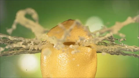 Half Lemon falling and splashing on whit... | Stock Video | Pond5