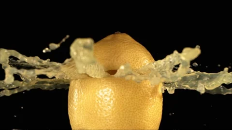 Half Lemon falling and splashing on whit... | Stock Video | Pond5