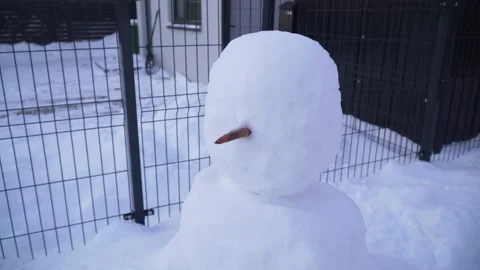 Half-made snowman in a garden in front o... | Stock Video | Pond5