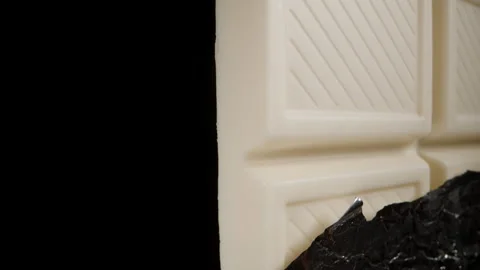 A half-unwrapped white chocolate bar rot... | Stock Video | Pond5