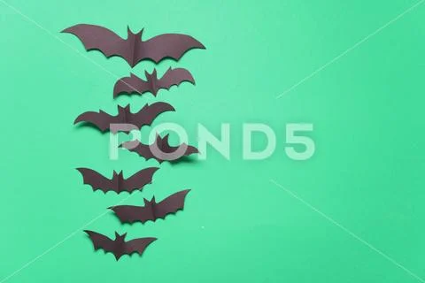 Halloween paper vampire bat decorations on a green background. ~ Hi Res ...