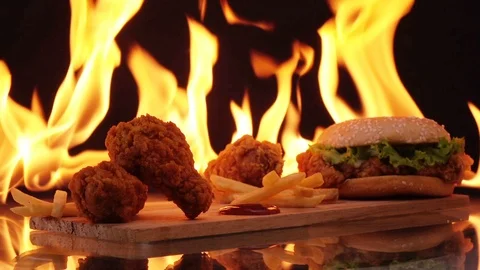 Hamburger and chicken fast food on fire ... | Stock Video | Pond5
