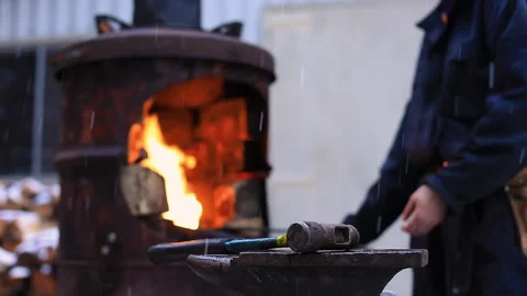 Hammer on anvil with woman near forge | Stock Video | Pond5
