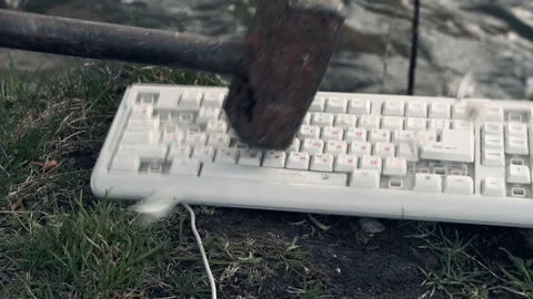 Hammer smashes a computer keyboard. Brok... | Stock Video | Pond5