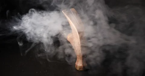 Hammer with smoke blowing isolated on bl... | Stock Video | Pond5