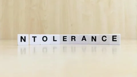 A hand changing the word tolerance to in... | Stock Video | Pond5