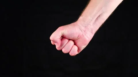 The hand is clenched into a fist as a sy... | Stock Video | Pond5