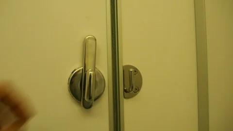 Hand close the toilet door by tweaking t... | Stock Video | Pond5