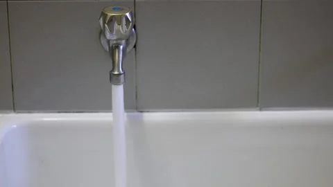 Hand closing a tap to block the flow of ... | Stock Video | Pond5