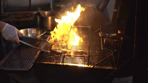 Hand cooking flame steak outdoor grill f... | Stock Video | Pond5