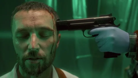 Hand of Criminal Holding Gun to Temple o... | Stock Video | Pond5