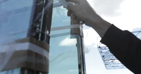 hand cuts the tape of the new glass unit | Stock Video | Pond5