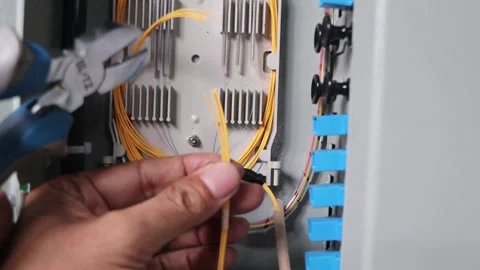 Hand cutting fiber optic cables | Stock Video | Pond5