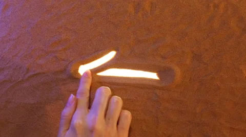 Hand drawing Arrow symbol in the sand. B... | Stock Video | Pond5