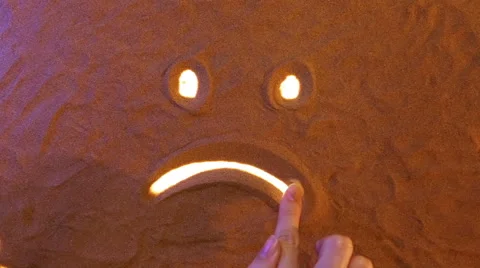 Hand drawing Sad Smile symbol in the san... | Stock Video | Pond5