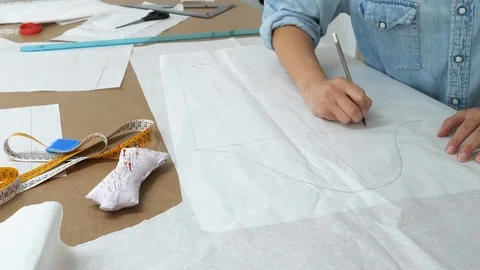 Hand of female tailor drawing pattern at... | Stock Video | Pond5