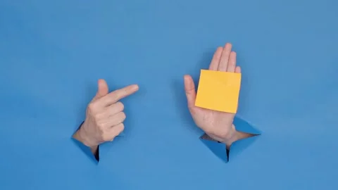hand gestures through holes on a blue ba... | Stock Video | Pond5