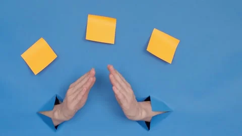hand gestures through holes on a blue ba... | Stock Video | Pond5