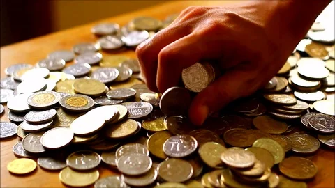Hand grabbing coins on a table | Stock Video | Pond5