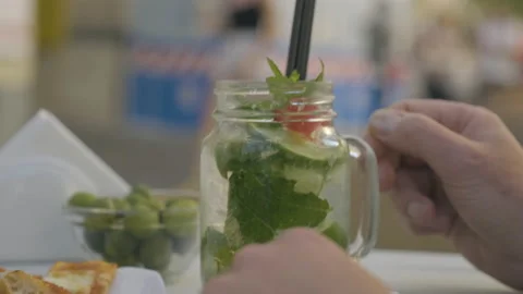 Hand grabbing jar with fresh drink | Stock Video | Pond5