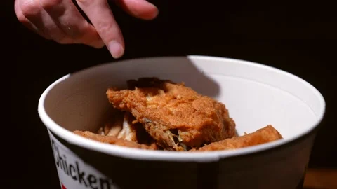 hand grabs fried chicken from to go cont... | Stock Video | Pond5