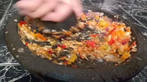 A Hand is Grinding Chili Sauce | Stock Video | Pond5