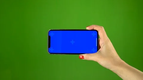 Hand holding a blue screen smartphone ov... | Stock Video | Pond5